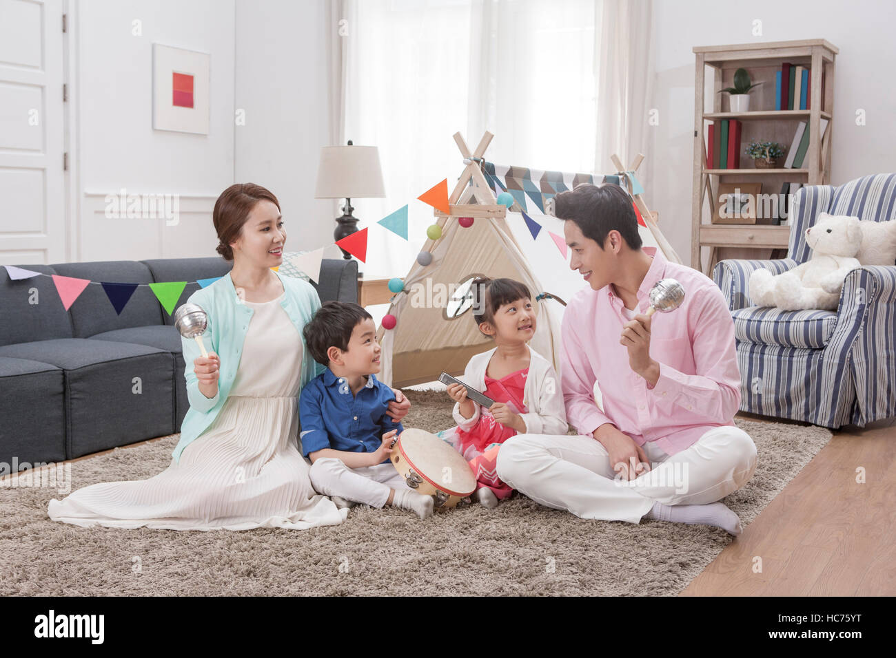 Harmonious family in living room Stock Photo - Alamy