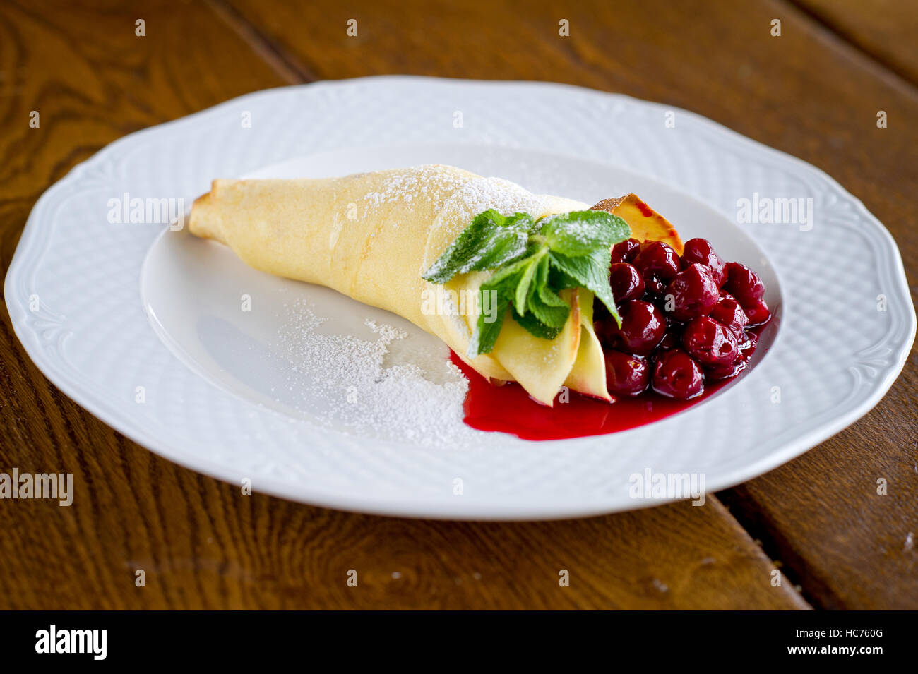 Sweet crepes with cherry for kids menu nicely decorated Stock Photo - Alamy