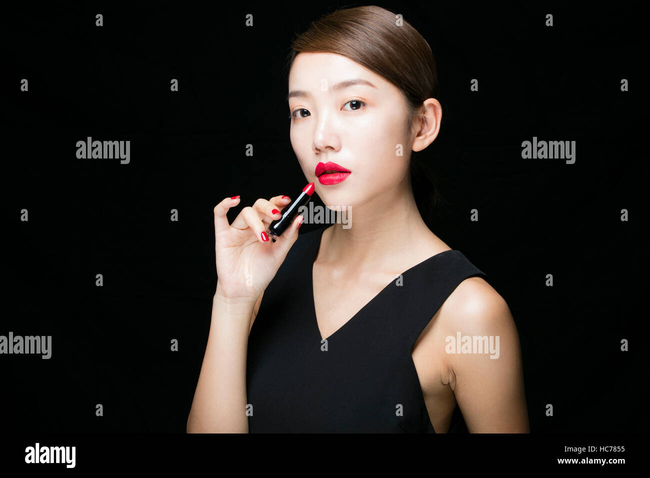 Portrait of young woman in black with red lips Stock Photo - Alamy
