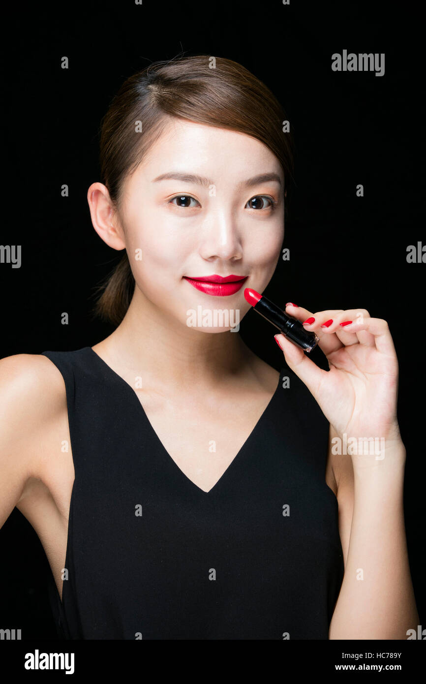 Portrait of young woman in black with red lips Stock Photo - Alamy