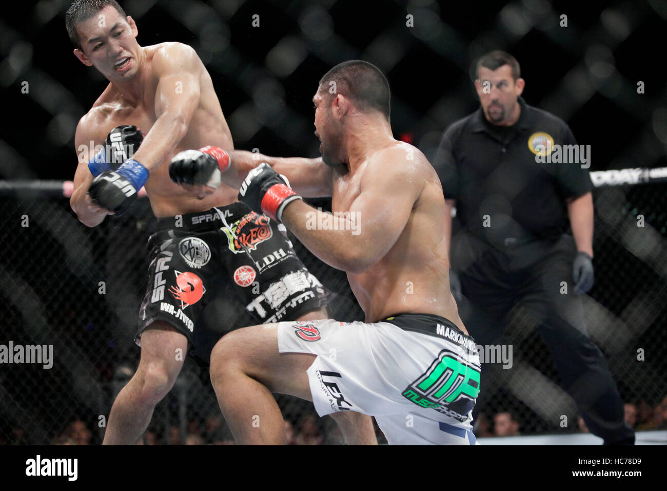 UFC fighter Mark Munoz, right, fights Yushin Okami at UFC-Live: Jones ...