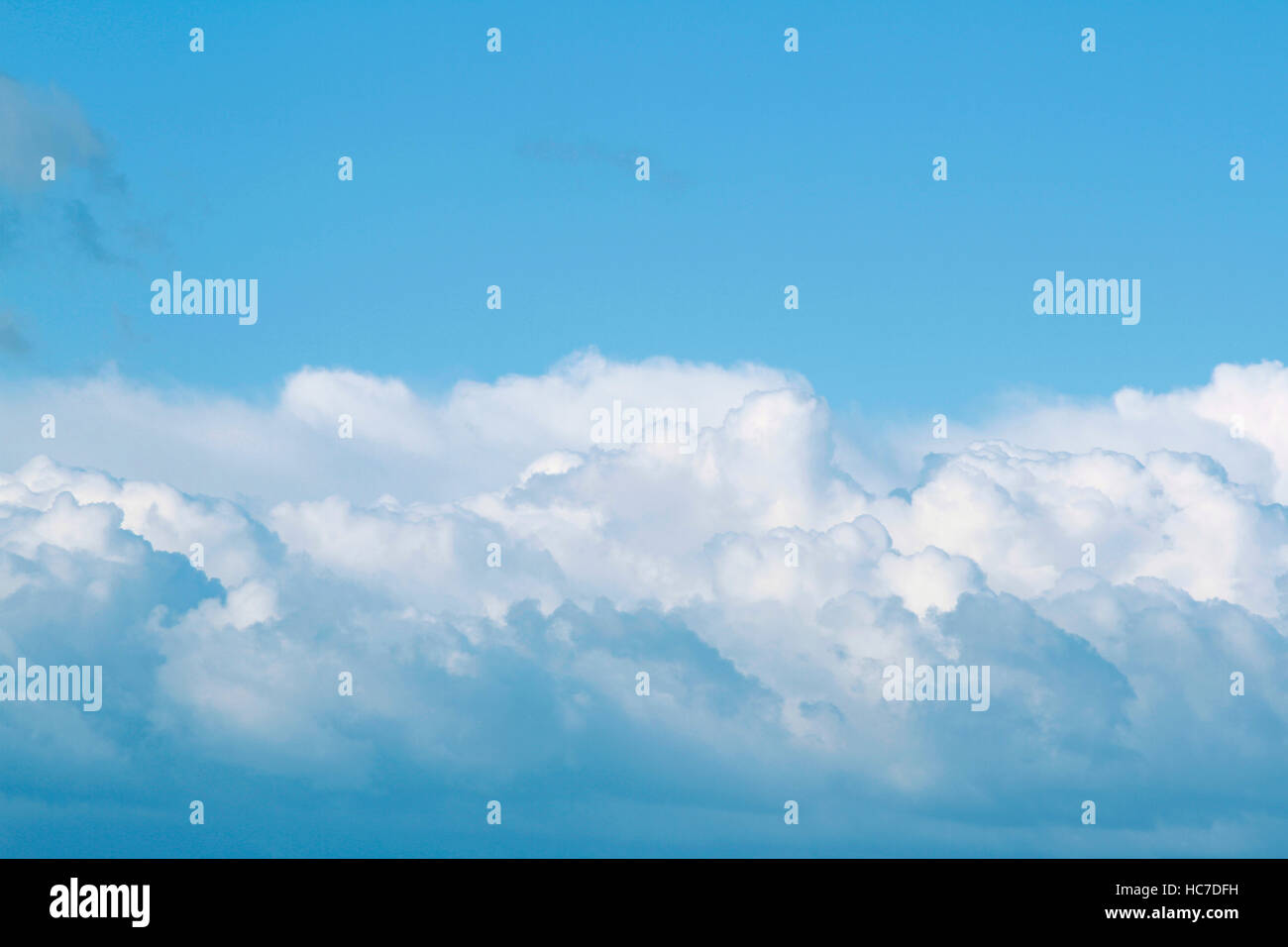 Fluffy white clouds in blue sky Stock Photo - Alamy