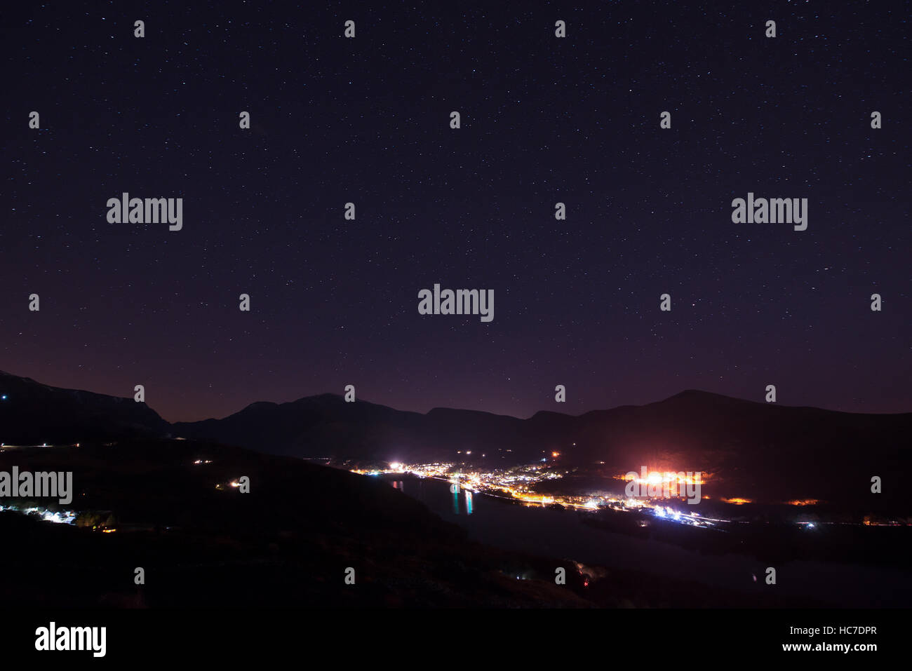Clear night sky with stars over Llanberis and Mount Snowdon in ...