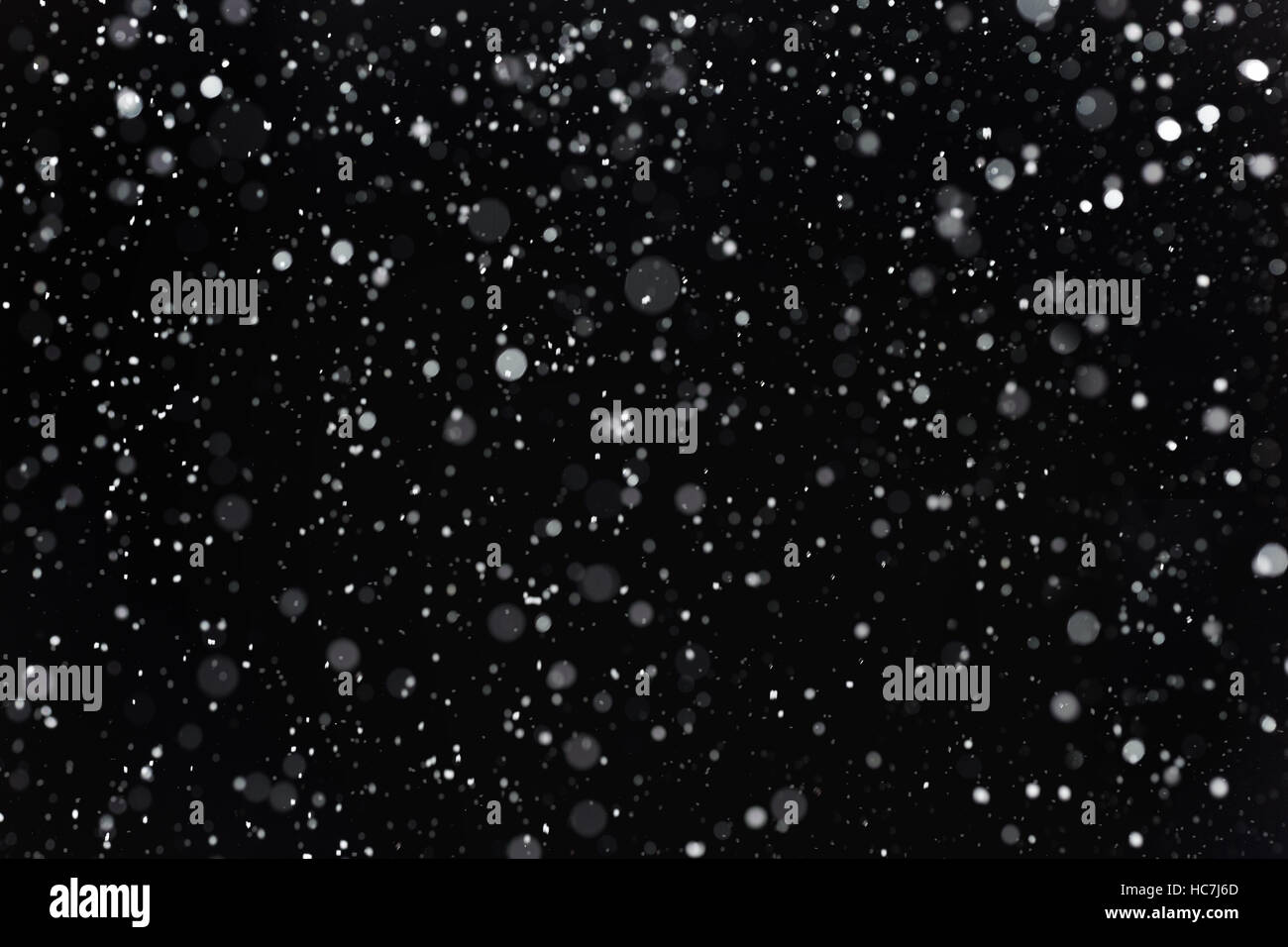 Real snow on black background Stock Photo - Alamy