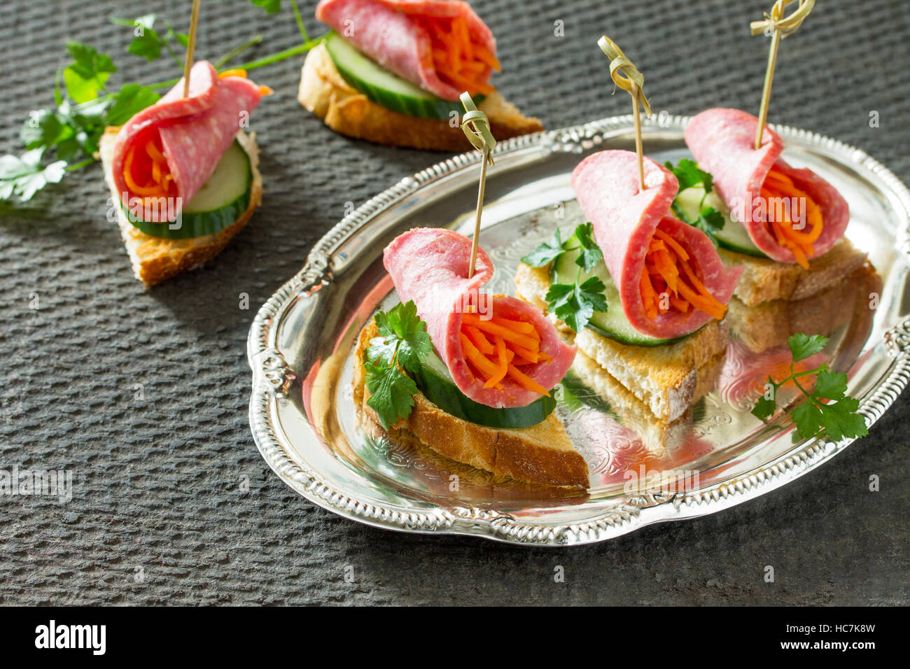 Holiday appetizer: Canapes on crispy bread with cucumber, carrots and ...