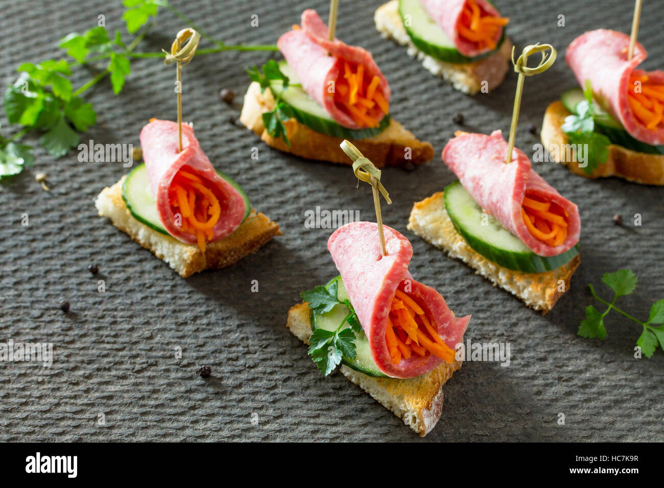 Holiday appetizer: Canapes on crispy bread with cucumber, carrots and ...