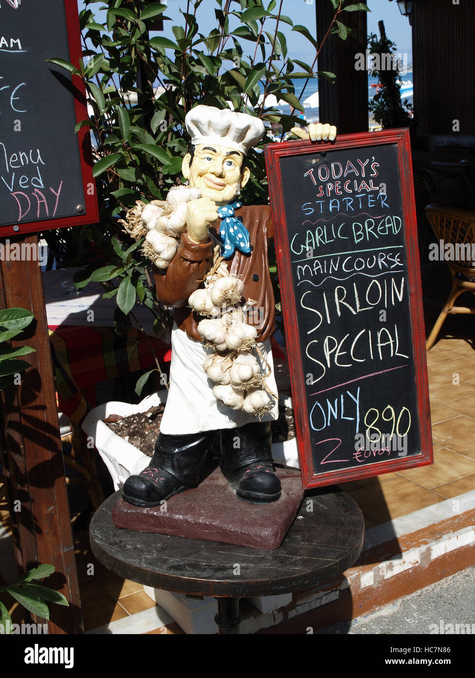 Chef figure holding blackboard at Roxanne Restaurant Roda Corfu Greece ...