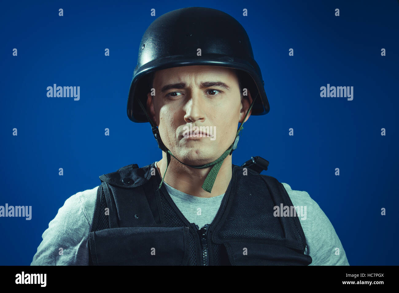 Security, paintball sport player wearing protective helmet aiming ...