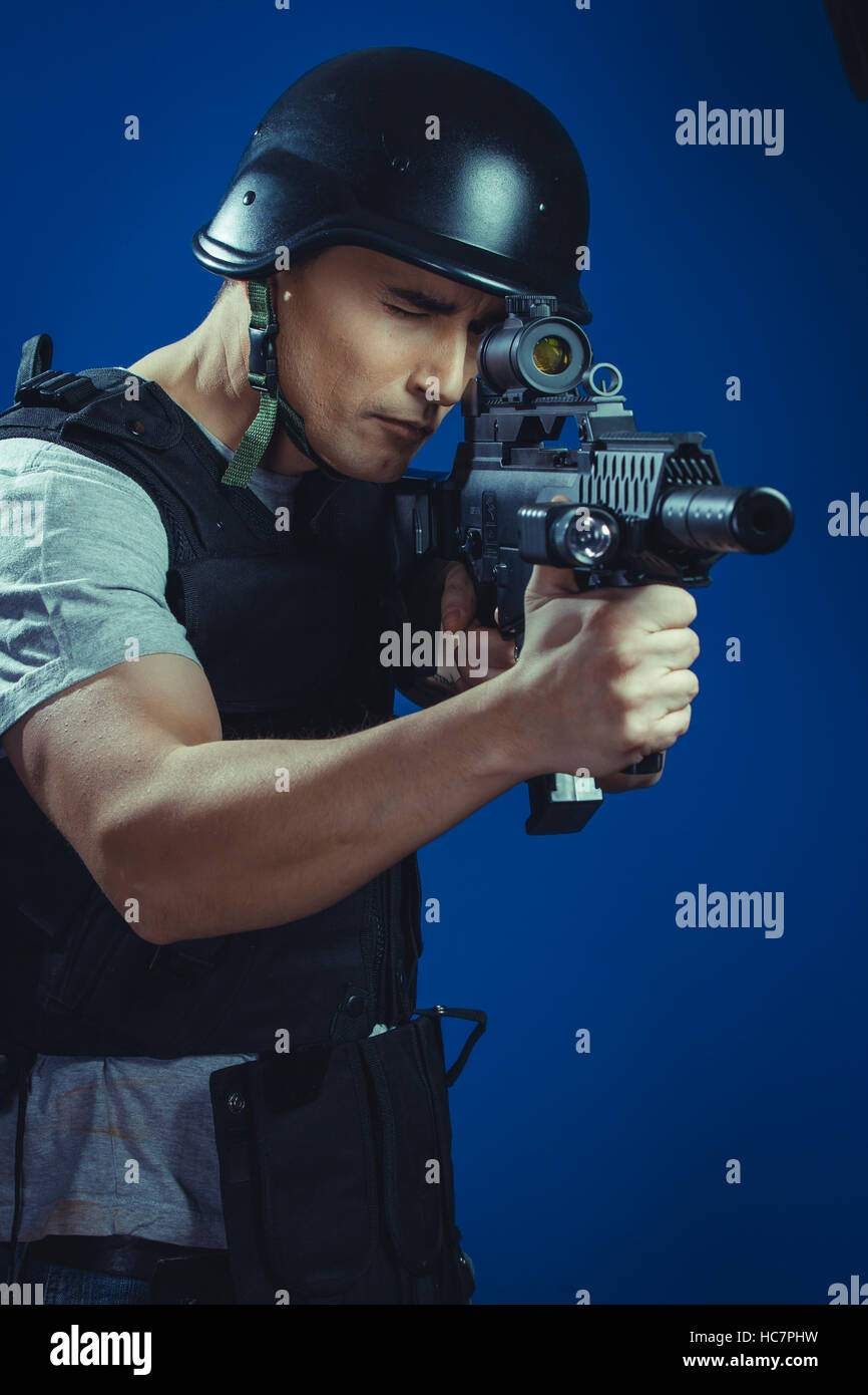 recreation player wearing protective helmet aiming pistol ,black armor ...