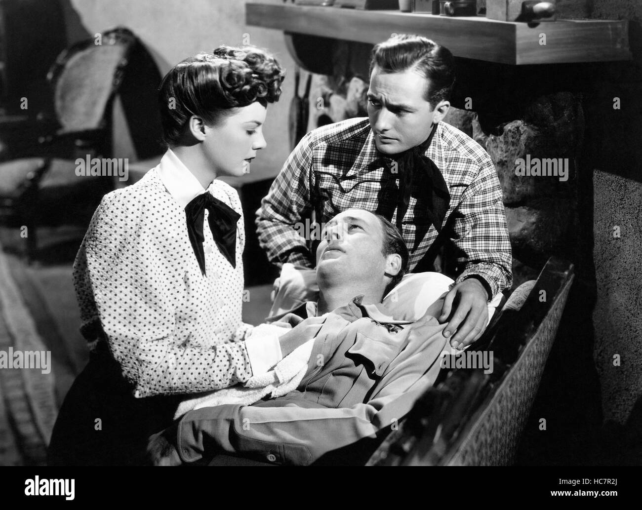 SUNSET PASS, from left, Nan Leslie, James Warren, (lying down), Robert Clarke, 1946 Stock Photo ...