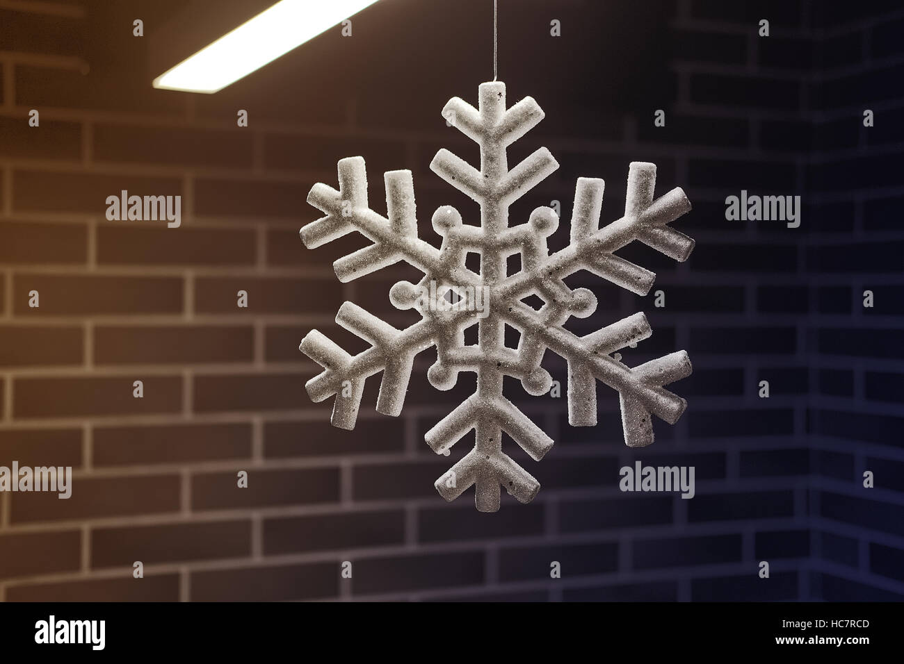 styrofoam snowflake in lonely dark room with brick walls Stock Photo Alamy