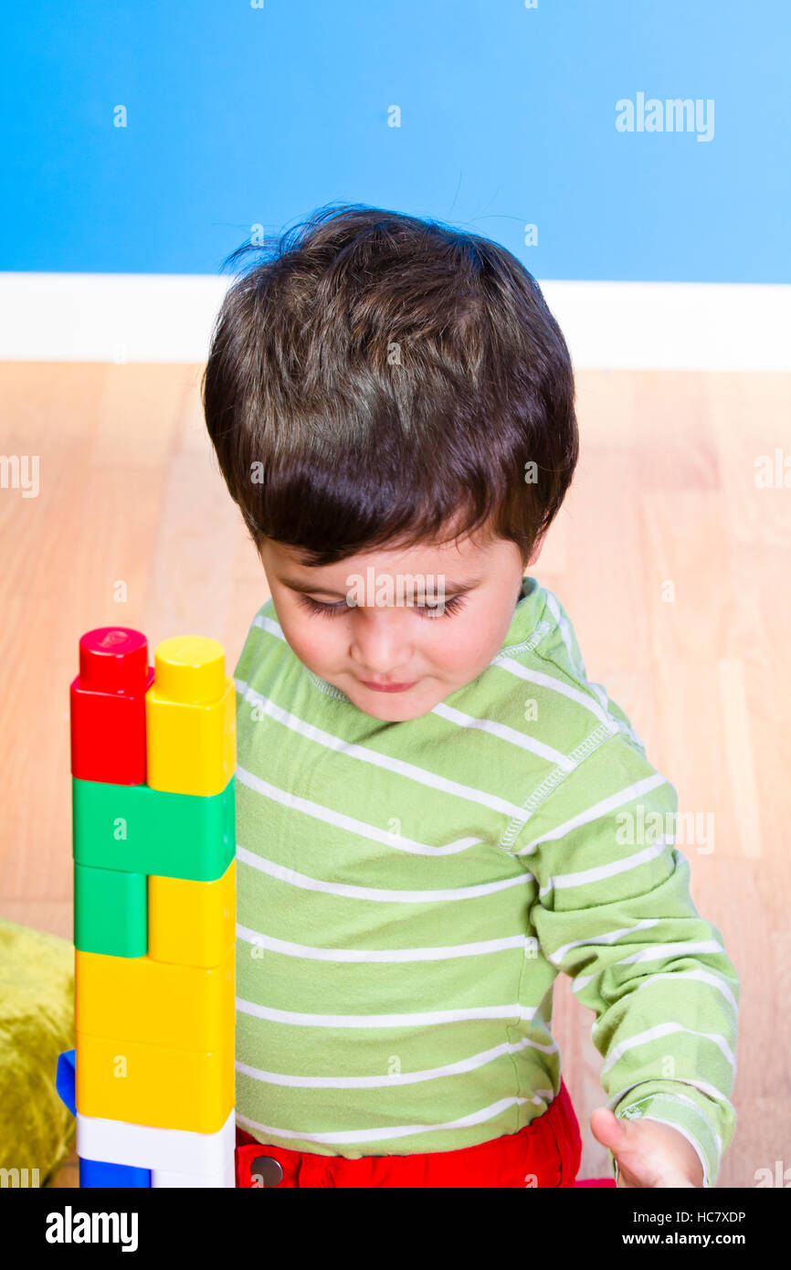 Education, Funny little boy playing with plastic colorful blocks ...