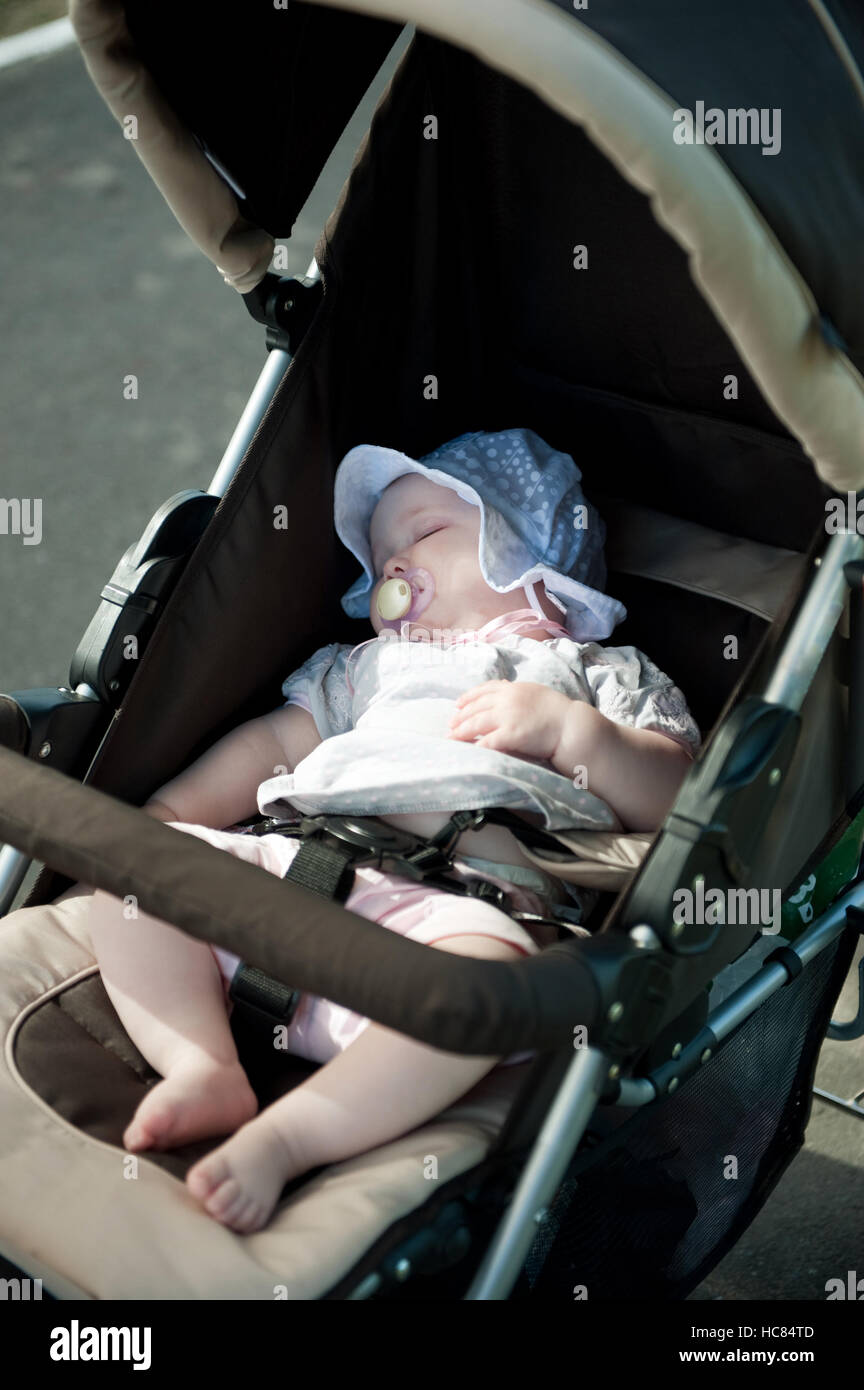 Little baby girl is sleeping in stroller Stock Photo - Alamy