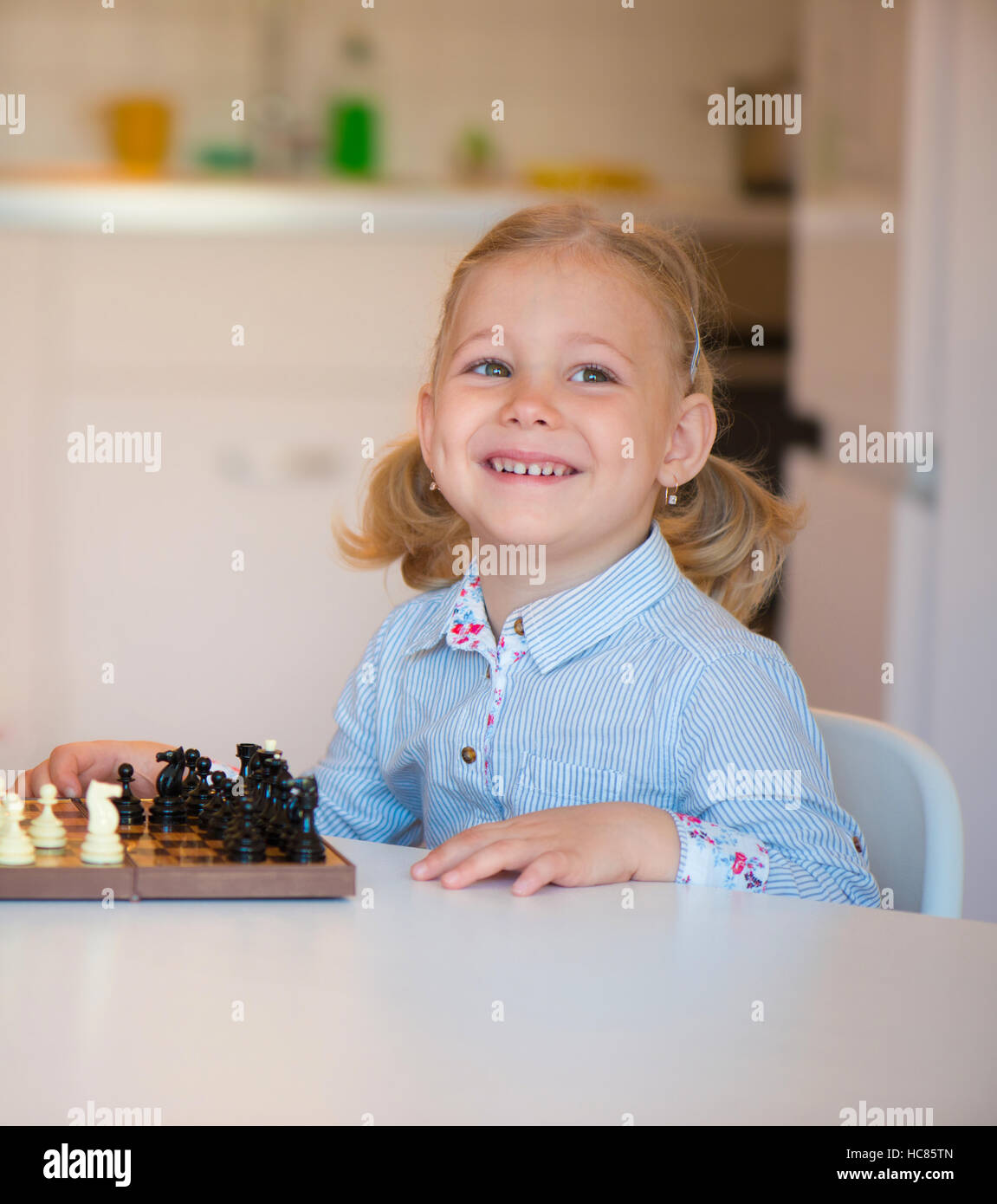 Portrait of beautiful little girl with chess Stock Photo - Alamy