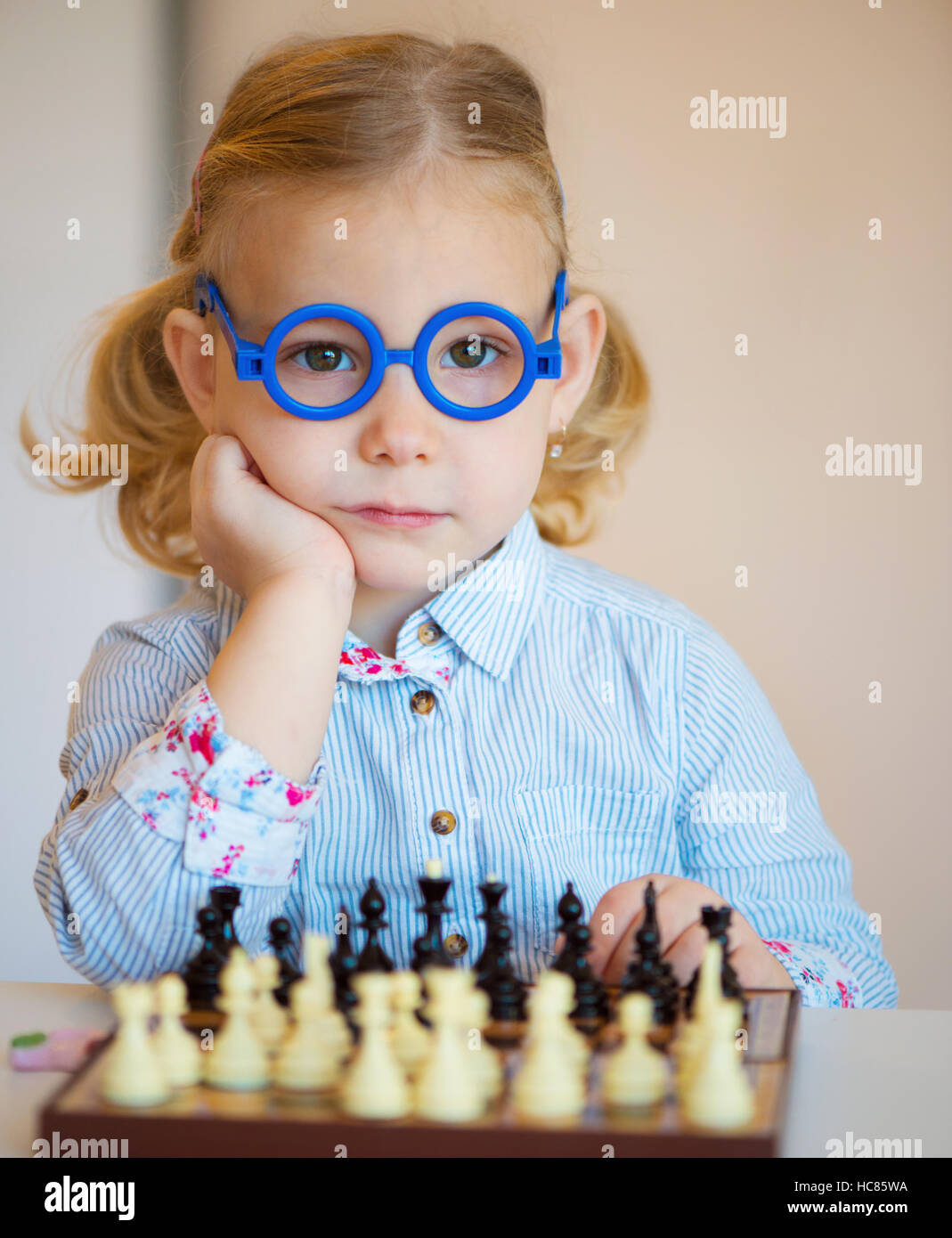 Portrait of beautiful little girl with chess Stock Photo - Alamy