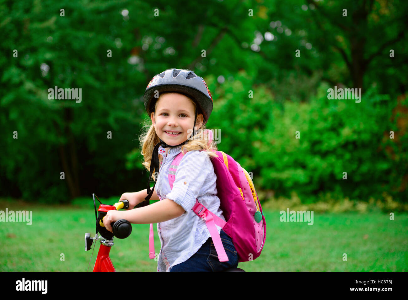 Pretty little girl ride with bicycle in summer park Stock Photo - Alamy