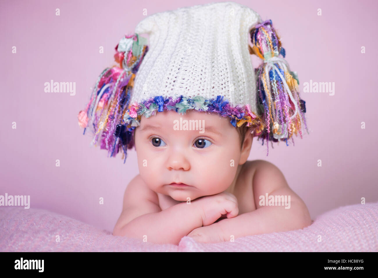 Beautiful little baby girl wearing pink knitted cap Stock Photo - Alamy