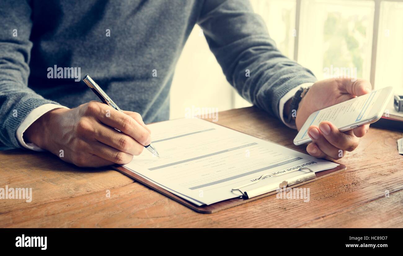 Man writing insurance application hi-res stock photography and images ...
