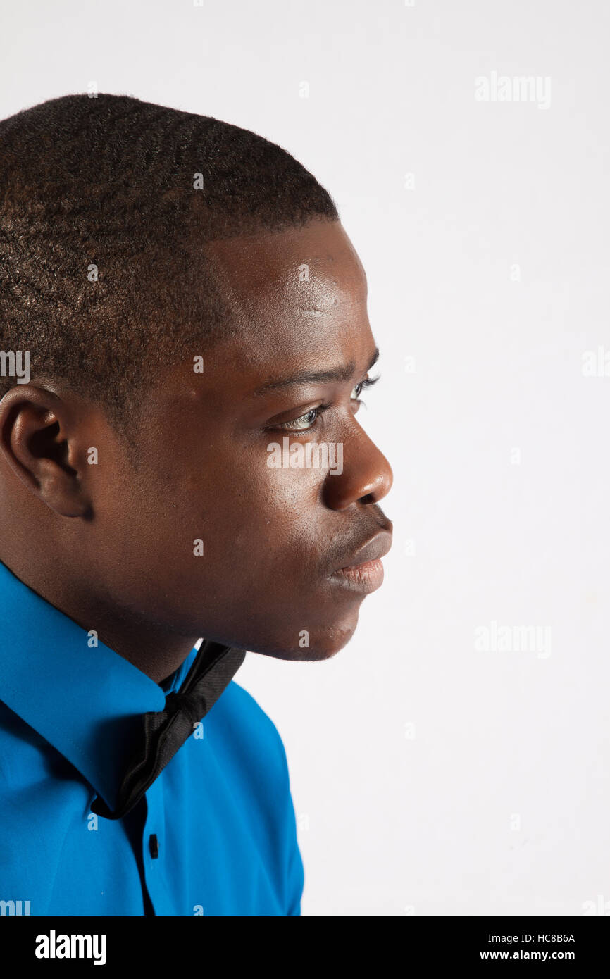Handsome Black man in a blue shirt, looking serious Stock Photo - Alamy