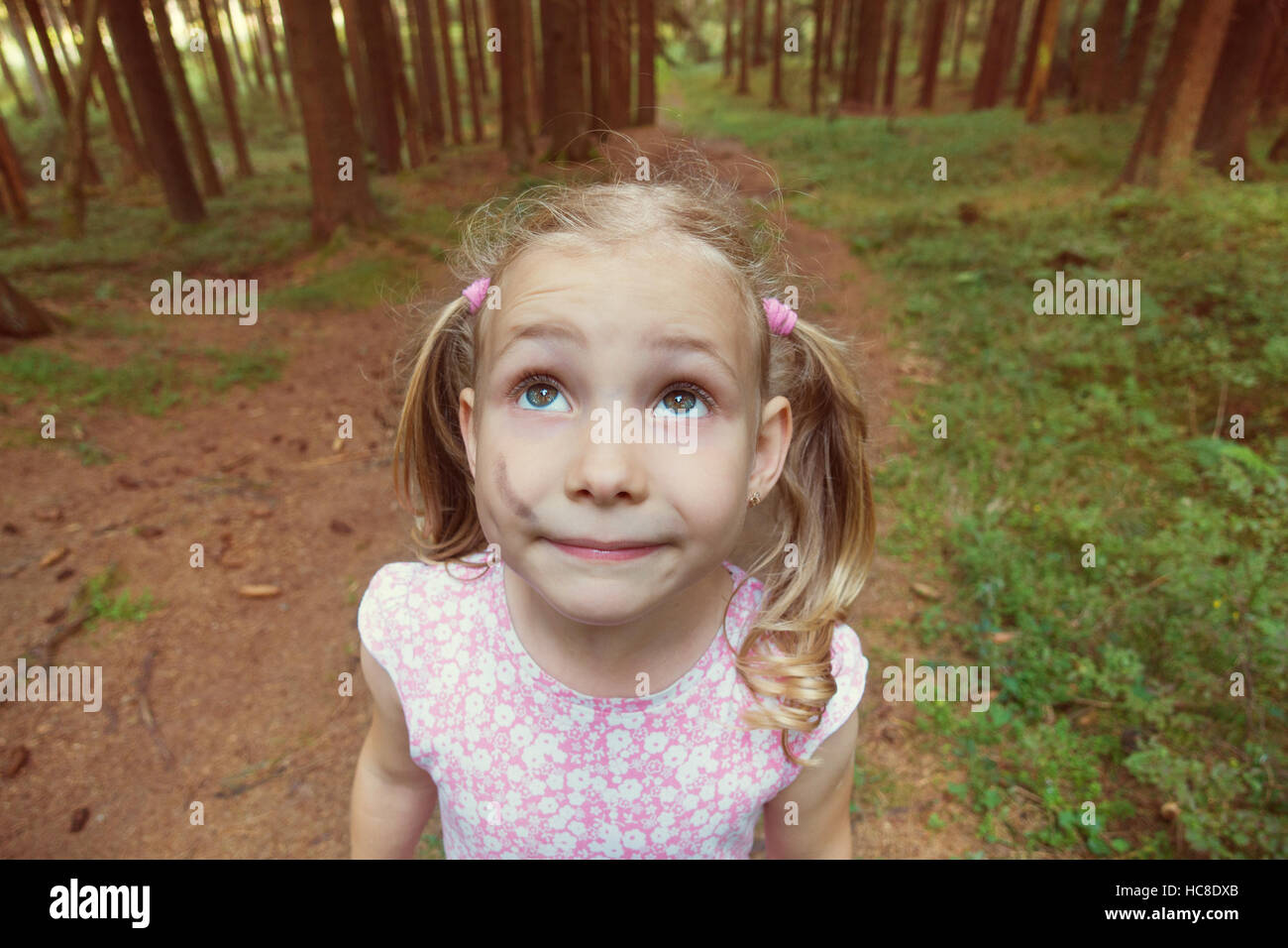 Alone little girl is afraid in dark forest. Face closeup Stock Photo ...