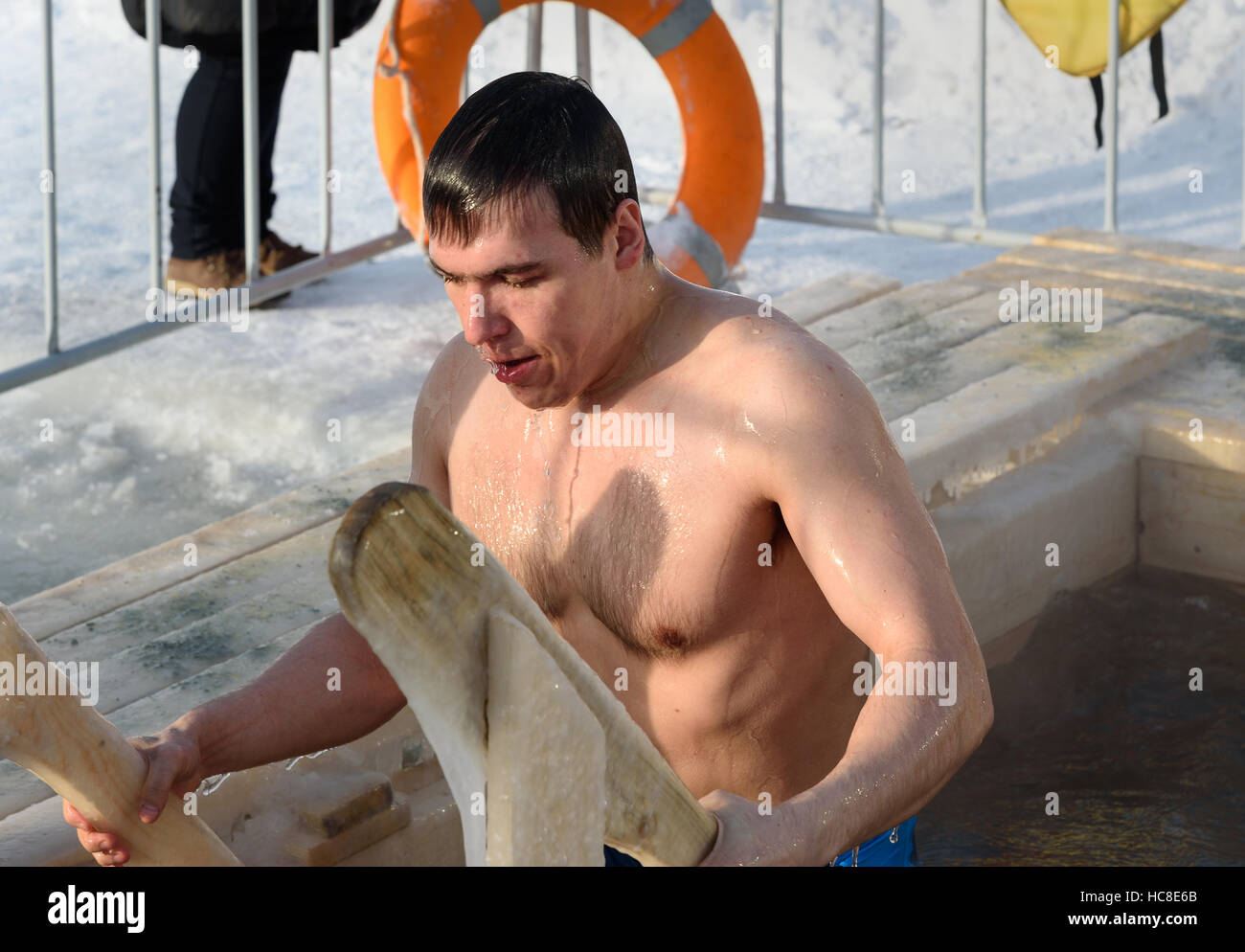 Man bathes into cold water of ice-hole on Epiphany day. Traditional ice ...