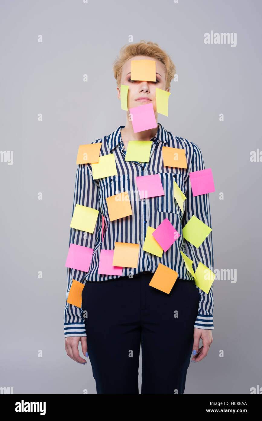Multi tasking woman with colorful papers Stock Photo - Alamy
