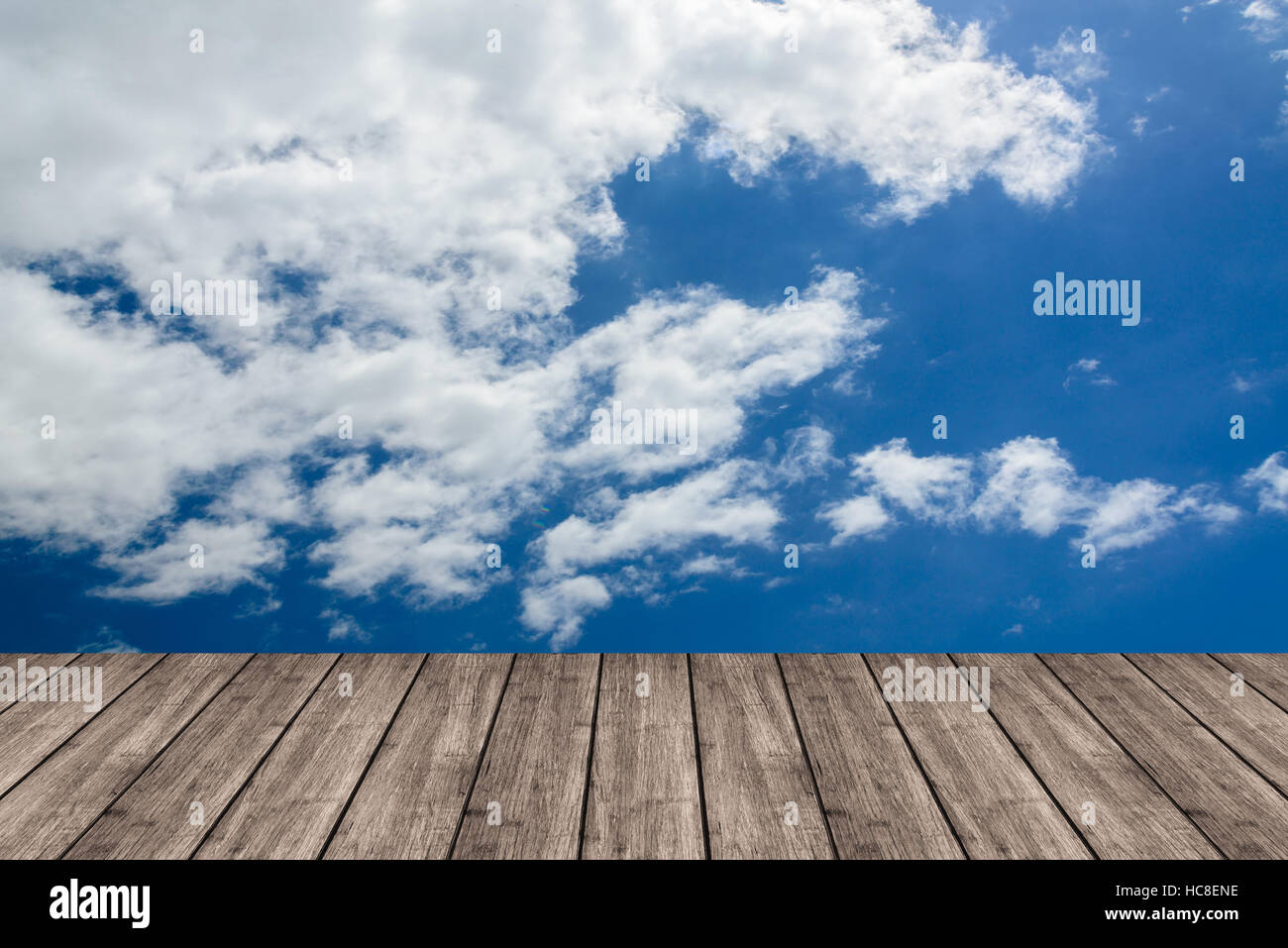 Wooden table or terrace on Deep blue sky and clouds. Space for your ...