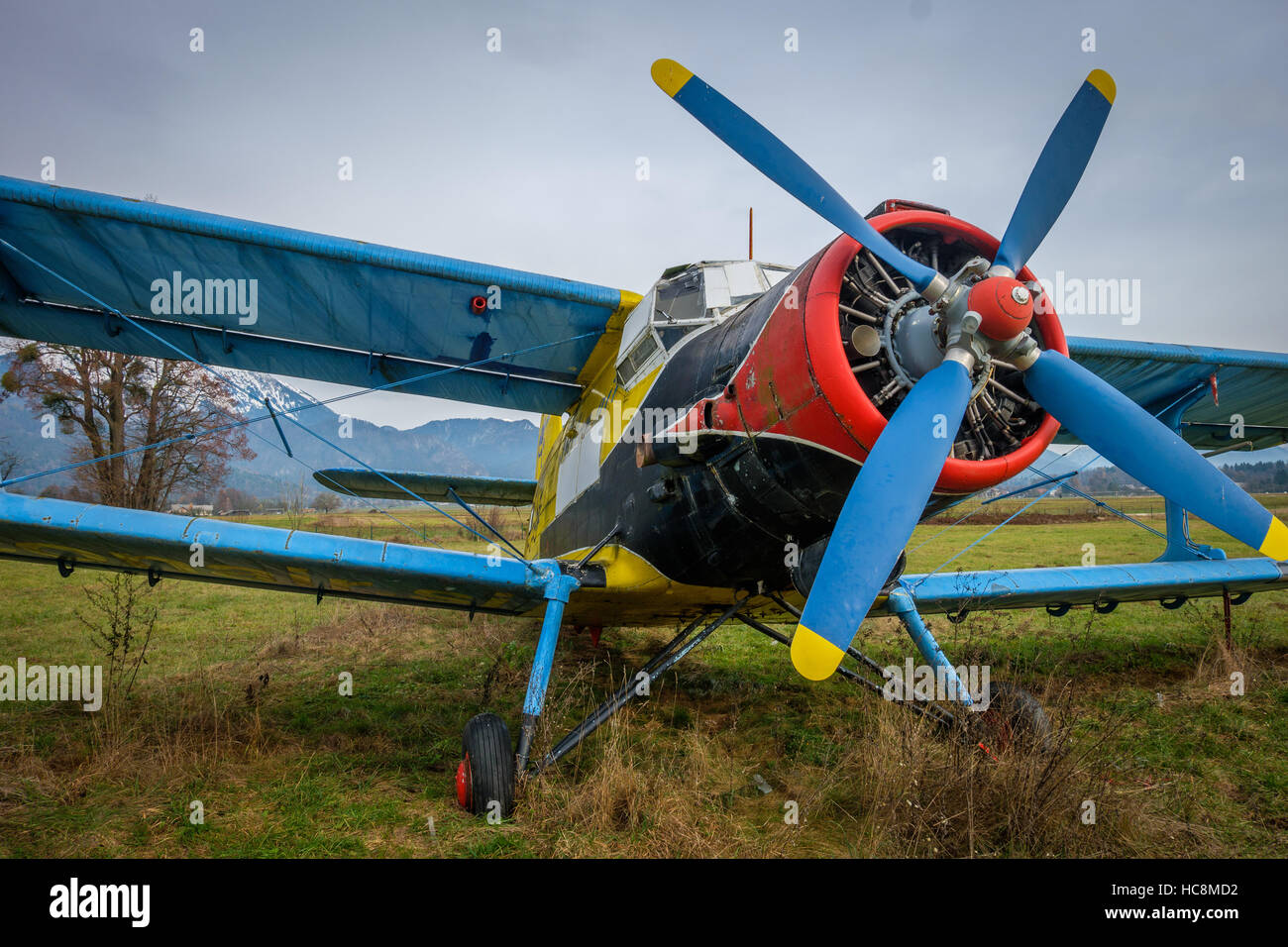 An old propeller plane, abandoned in the middle od a field near an ...