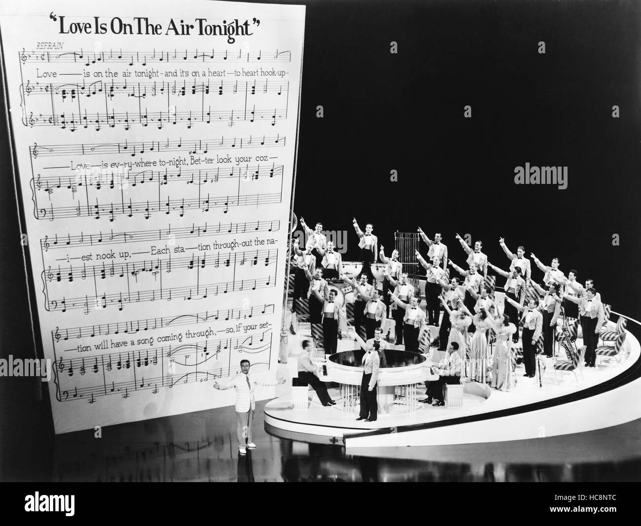 VARSITY SHOW, from left: Dick Powell, Fred Waring and his ...
