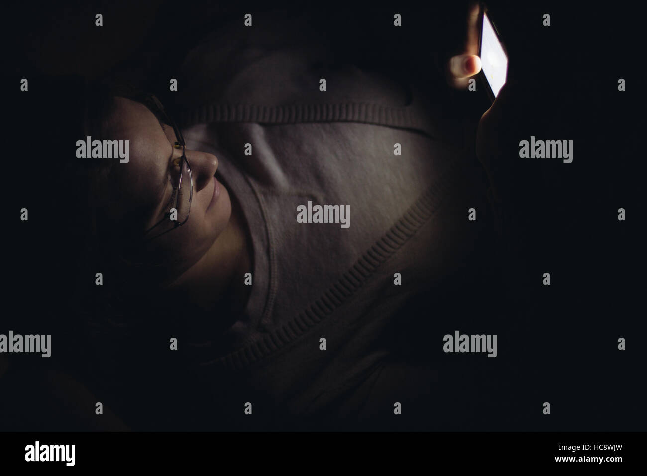 Woman dark room bed hi-res stock photography and images - Alamy