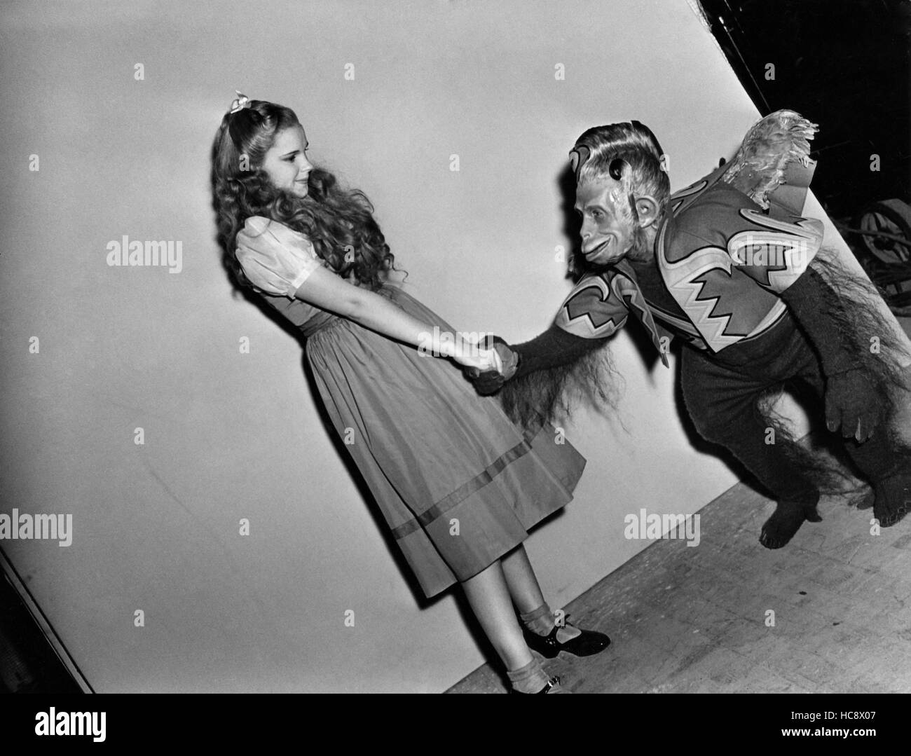 THE WIZARD OF OZ, Judy Garland and a flying monkey shake hands between ...
