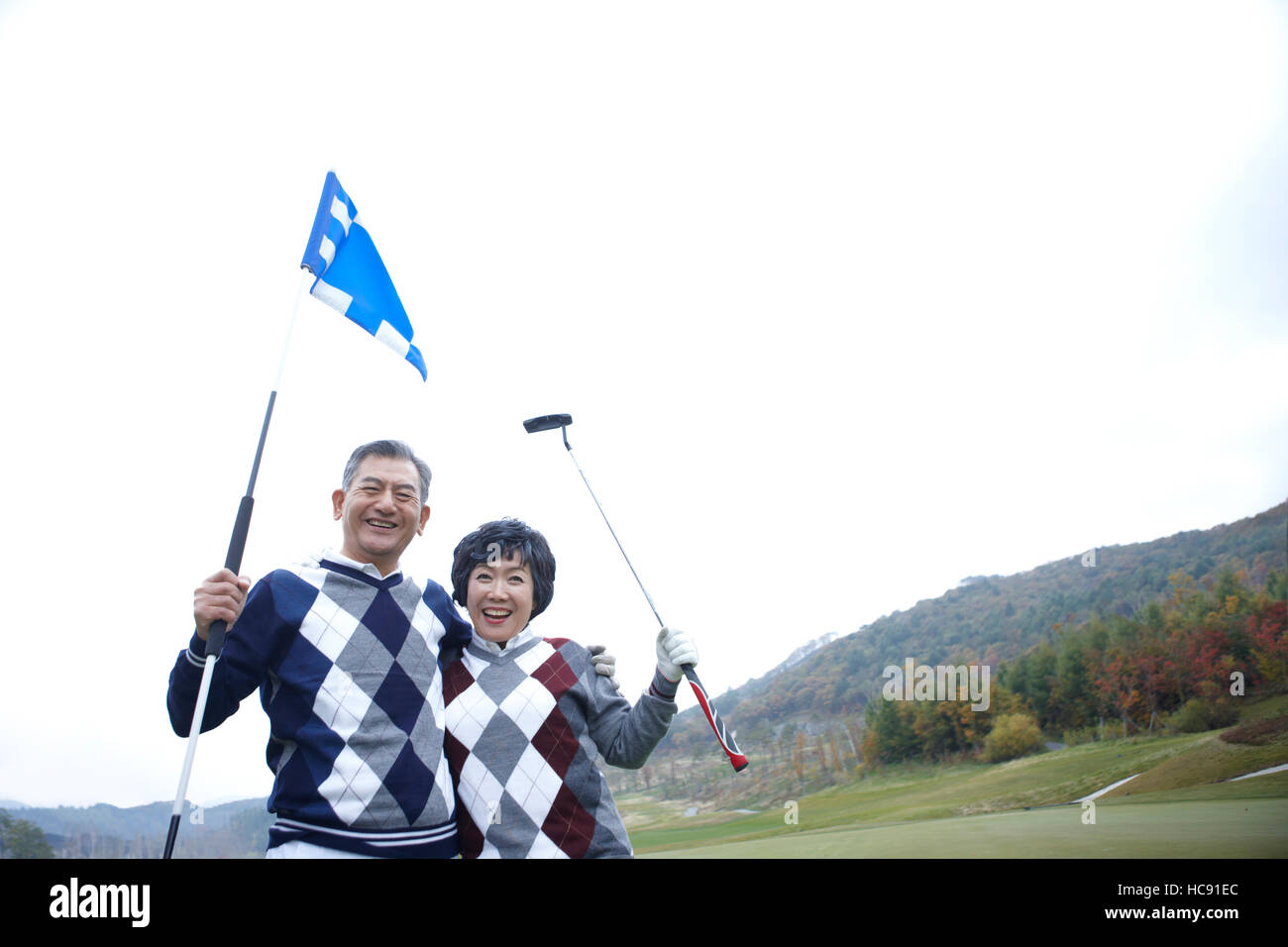 Portrait of smiling senior couple golfers hugging Stock Photo - Alamy
