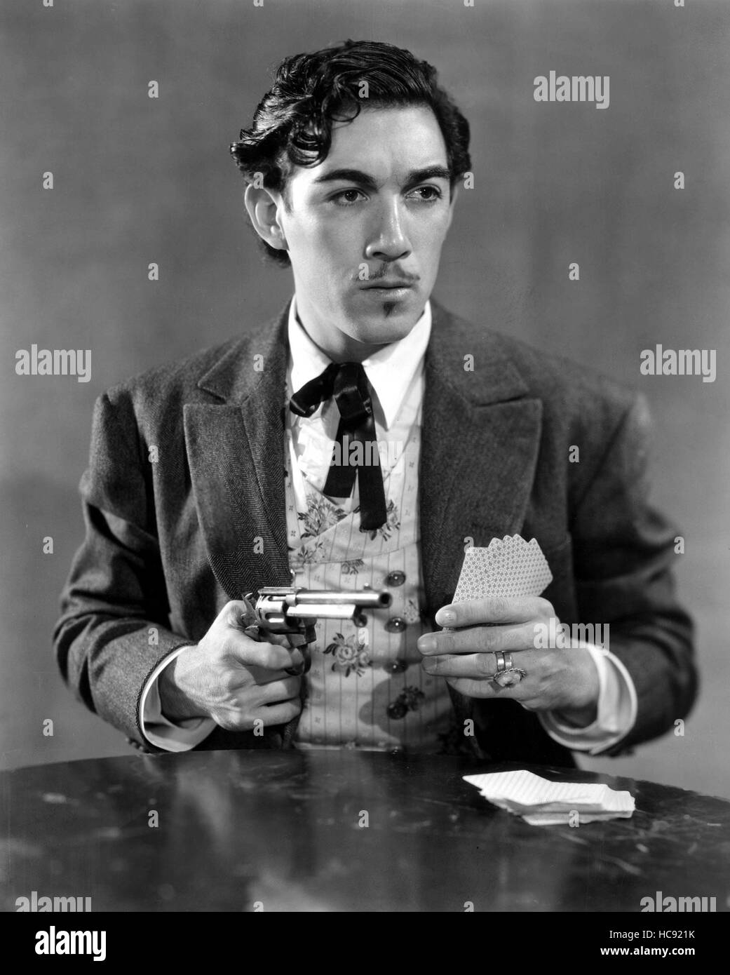 UNION PACIFIC, Anthony Quinn, pointing gun with cards in hand, 1939 ...