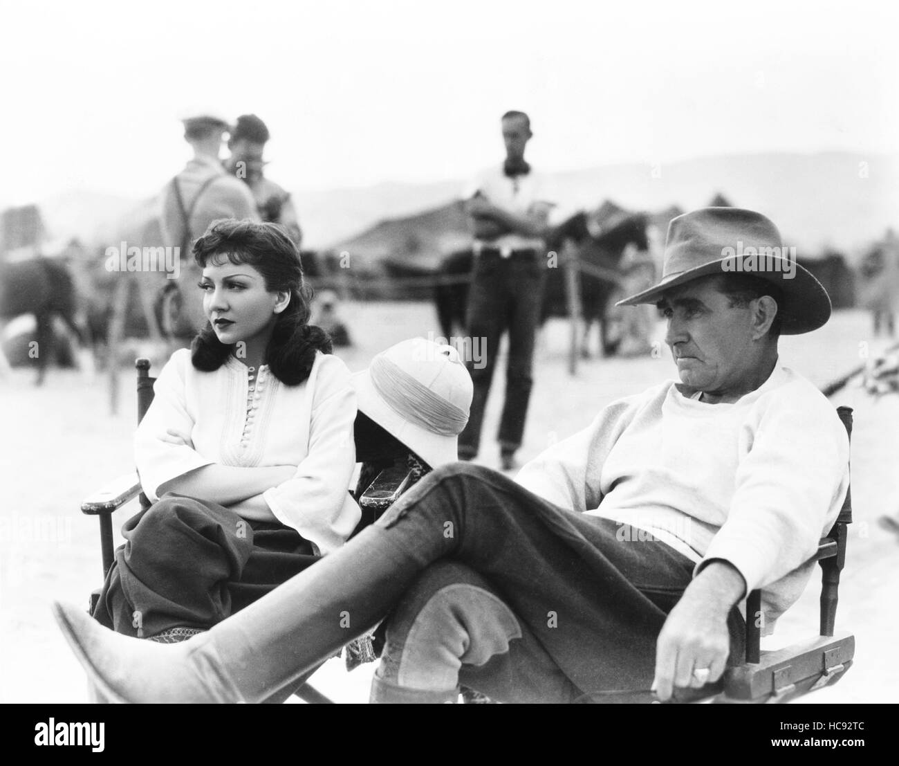 UNDER TWO FLAGS, from left: Claudette Colbert, director Frank Lloyd on ...