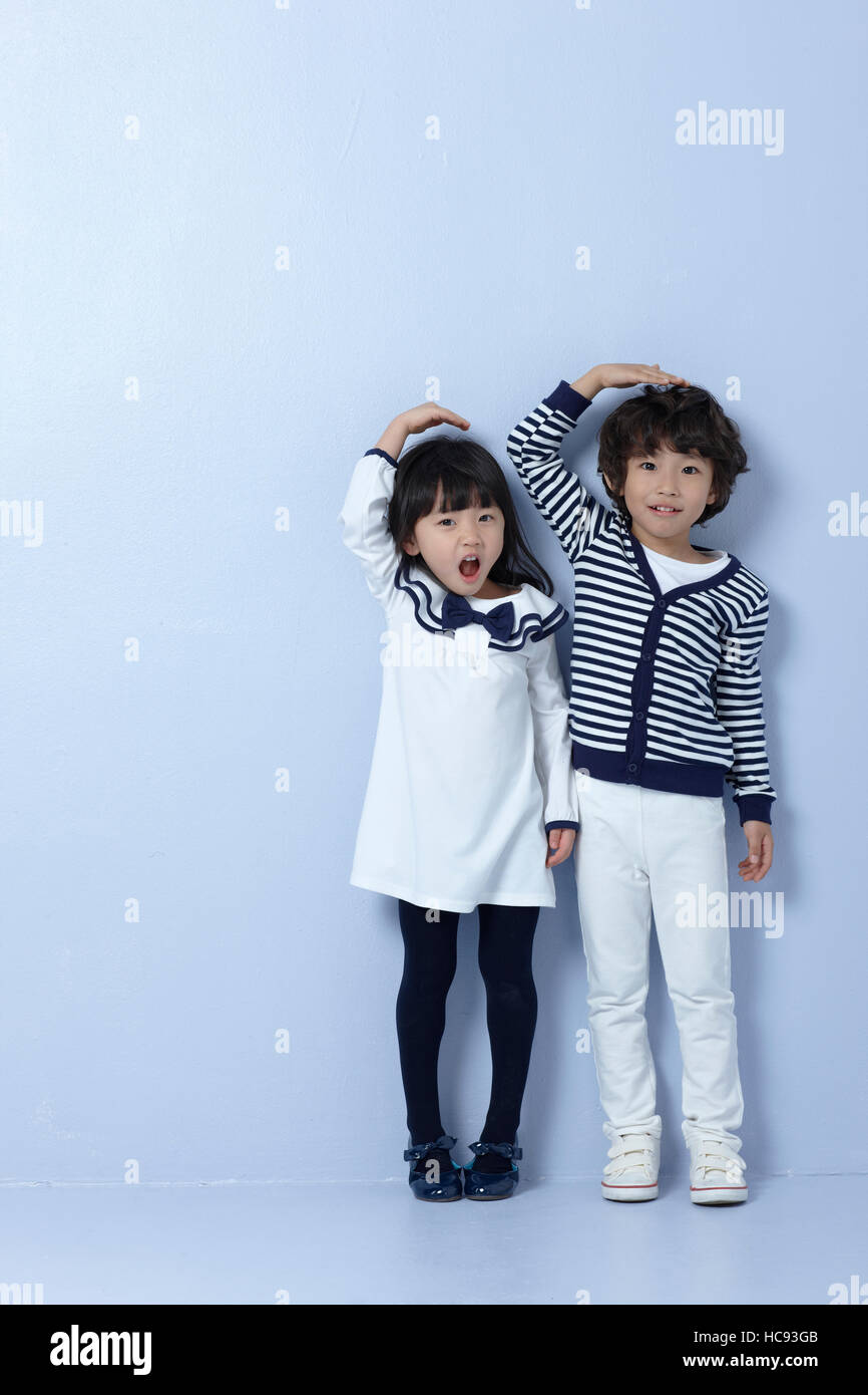 Smiling boy and girl standing Stock Photo - Alamy