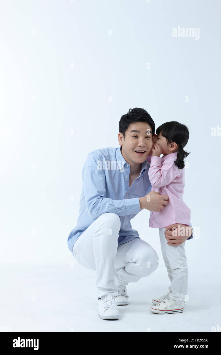 Smiling father and daughter talking in a whisper Stock Photo - Alamy