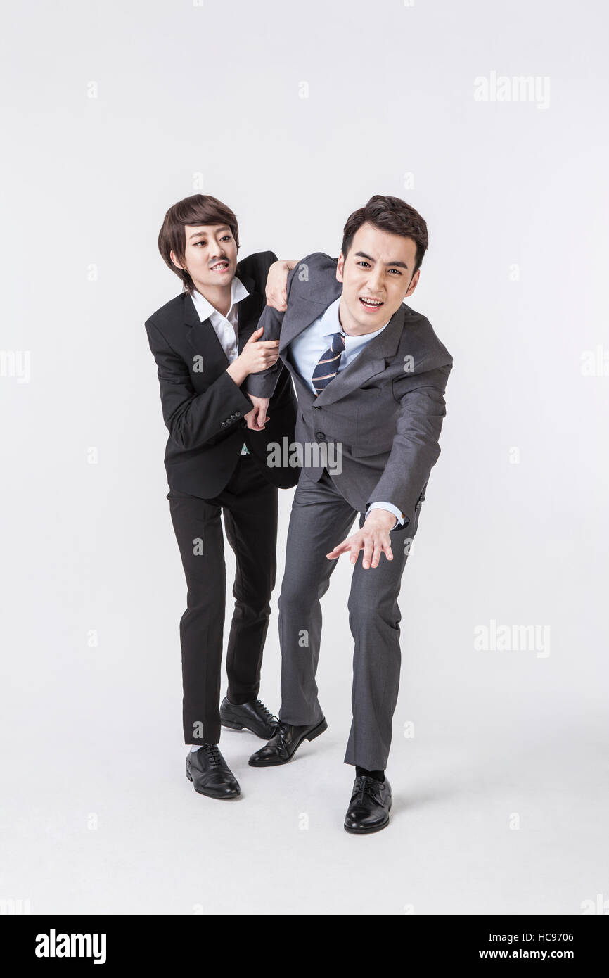 Businessman and woman disguising herself as businessman Stock Photo - Alamy
