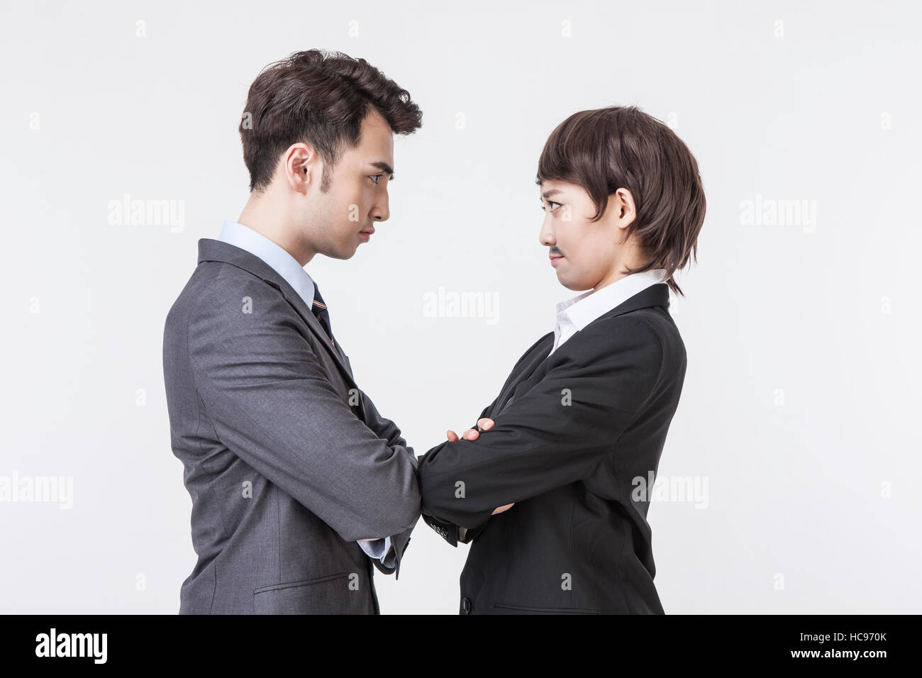 Woman disguising herself as businessman facing a businessman Stock ...