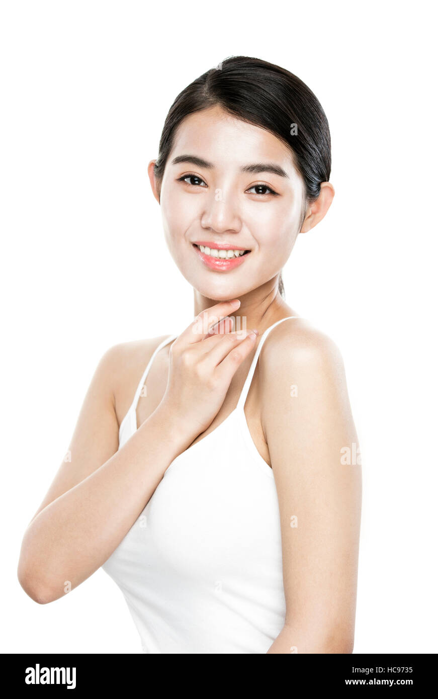 Portrait of young smiling woman touching her neck Stock Photo - Alamy
