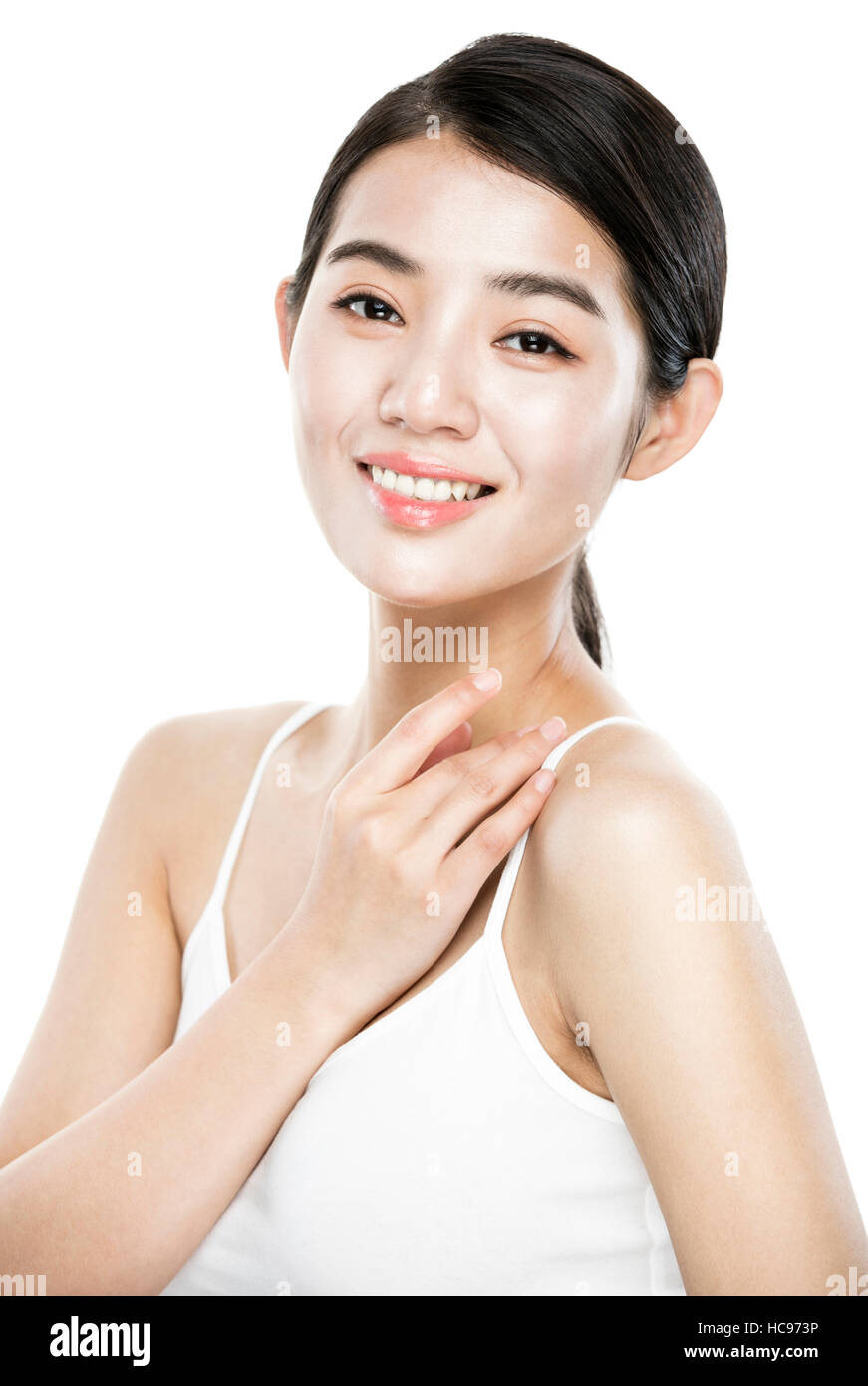 Portrait of young smiling woman touching her neck Stock Photo - Alamy