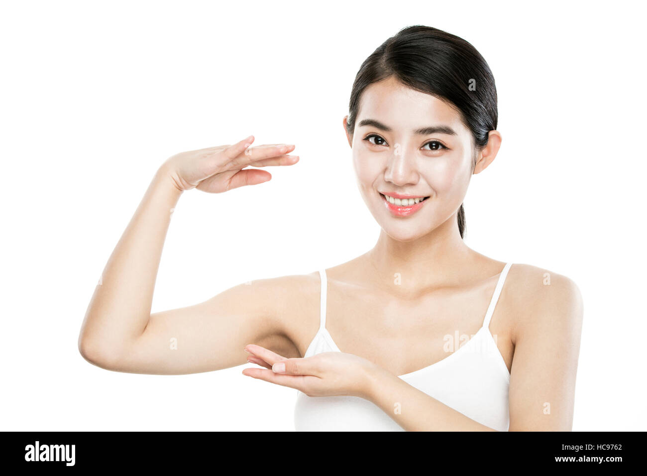 Portrait of young smiling woman holding arms Stock Photo - Alamy