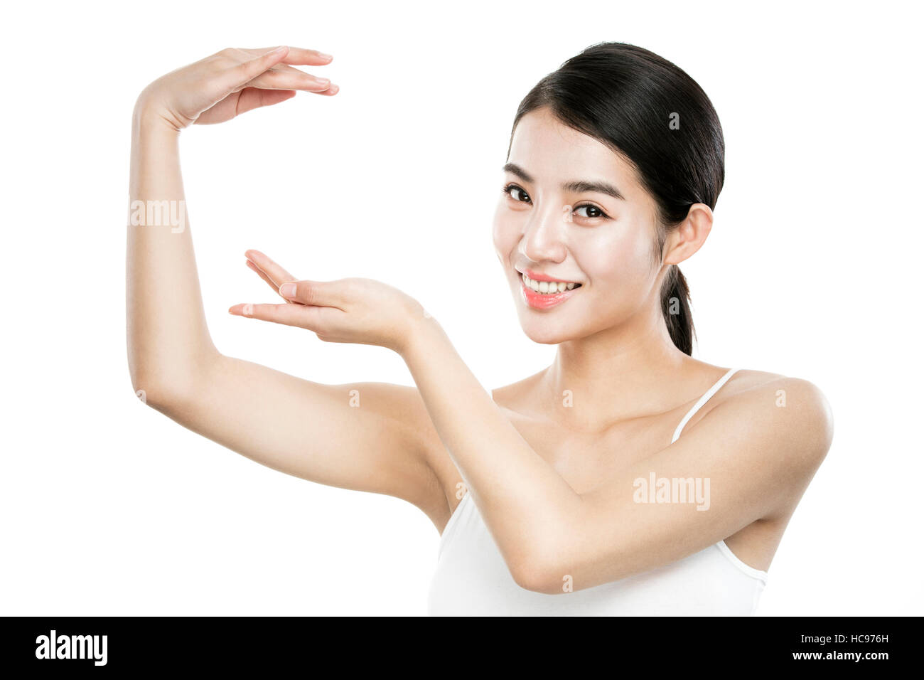 Portrait of young smi woman holding arms Stock Photo - Alamy