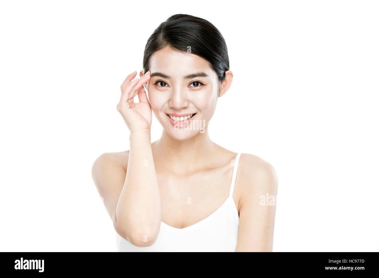 Portrait of young smiling woman touching her face Stock Photo - Alamy