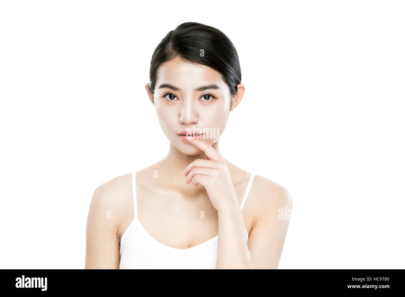 Portrait of young smiling woman touching her lips Stock Photo - Alamy