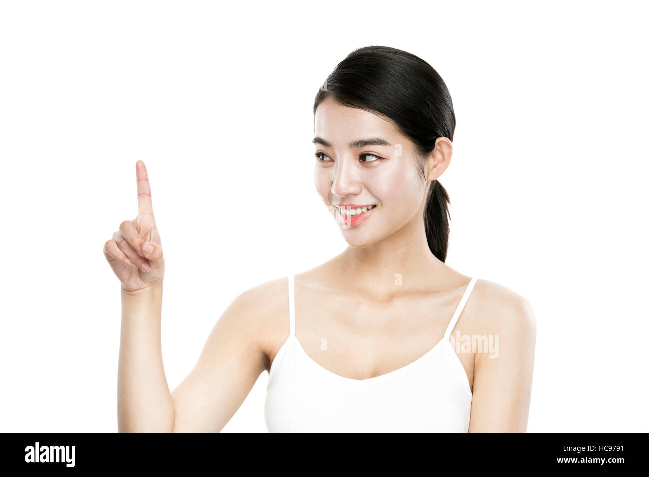 Portrait of young smiling woman standing index finger Stock Photo - Alamy