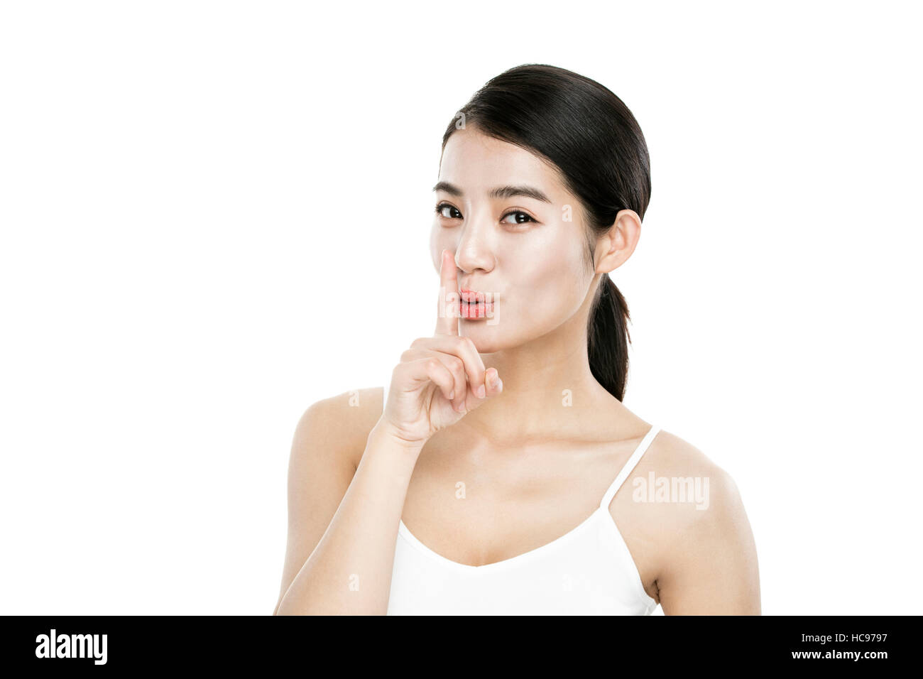 Portrait of young smiling woman with hush sign Stock Photo - Alamy