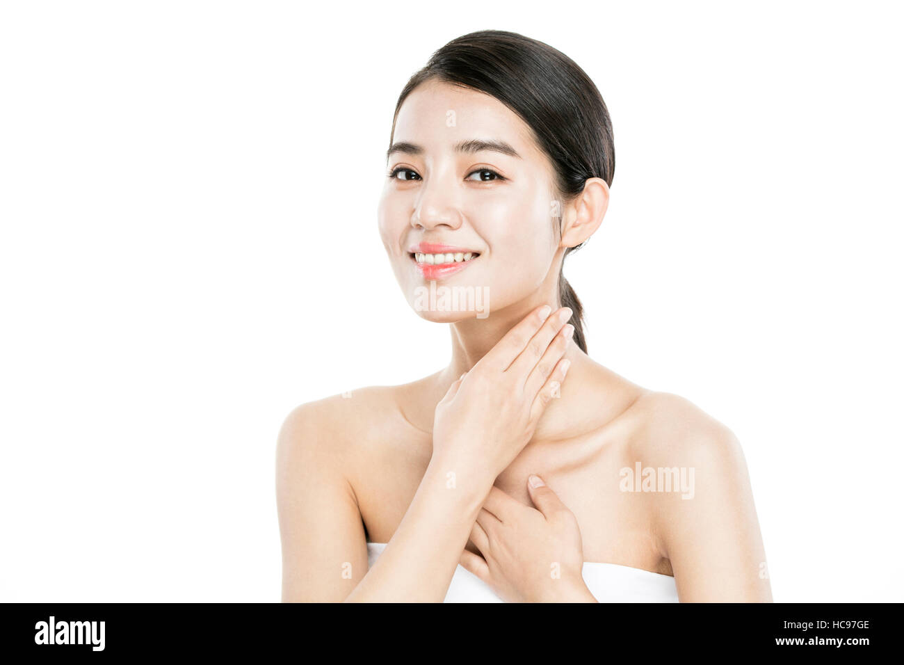 Portrait of young smiling woman massaging her face Stock Photo - Alamy