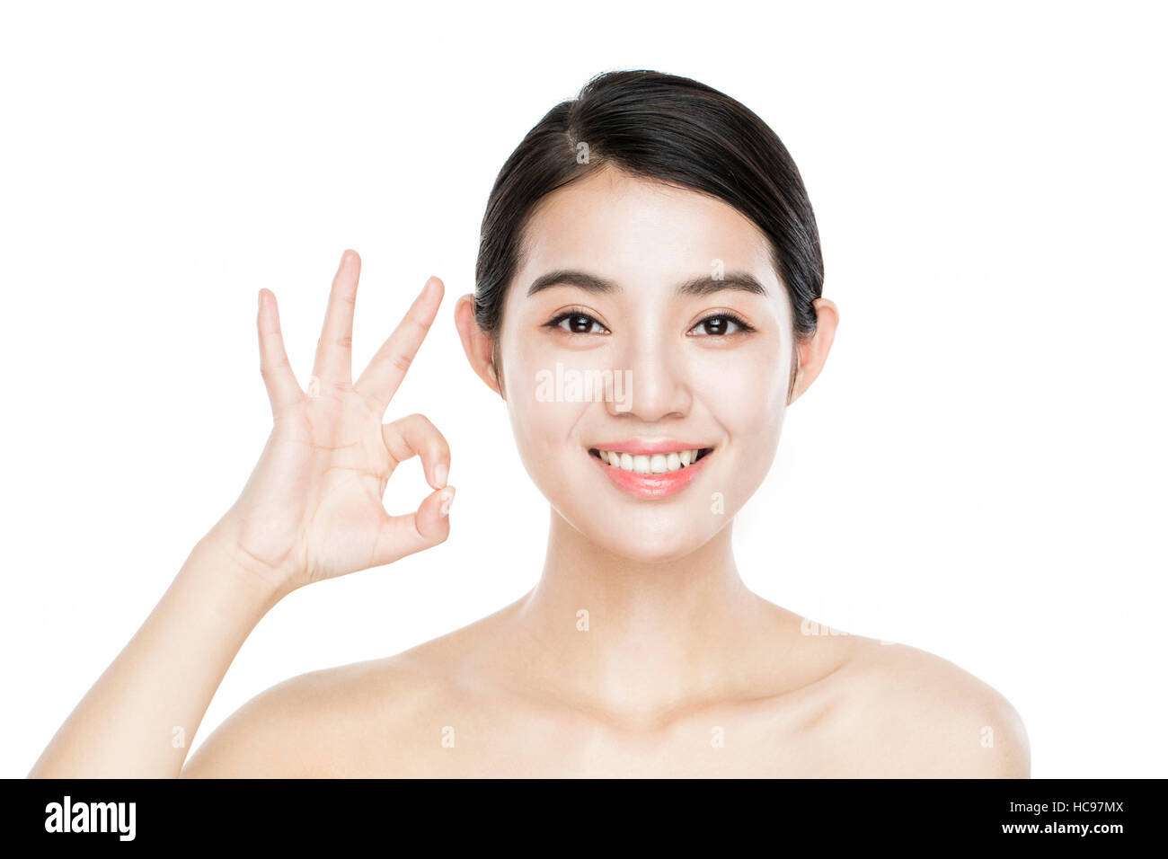 Portrait of young smiling woman with okay sign Stock Photo - Alamy