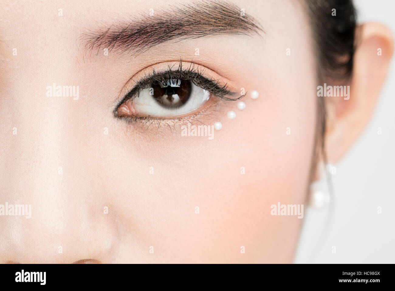 Bride's eye decorated with pearls below Stock Photo - Alamy