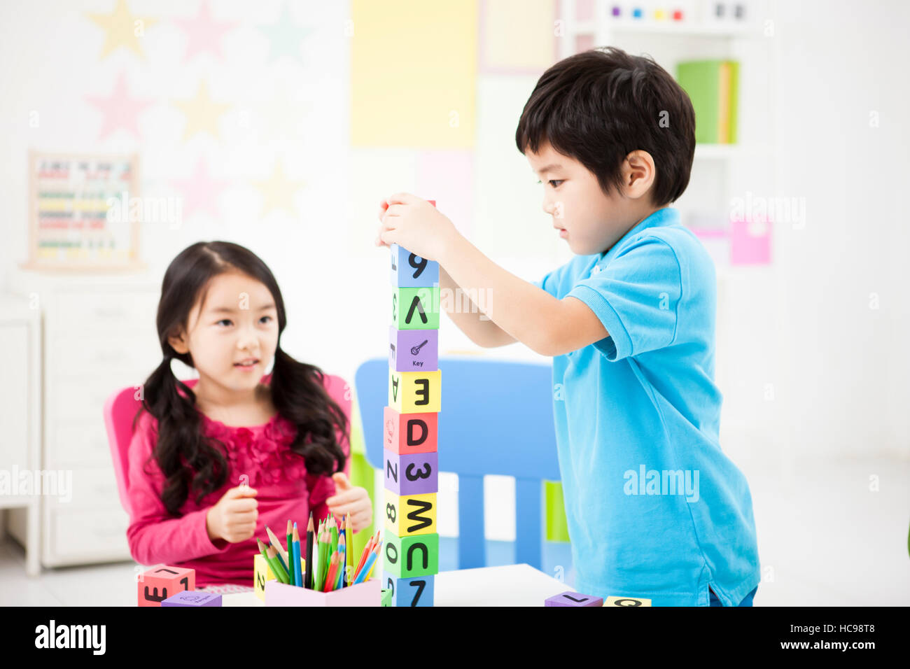 Smiling boy and girl playing with blocks Stock Photo - Alamy